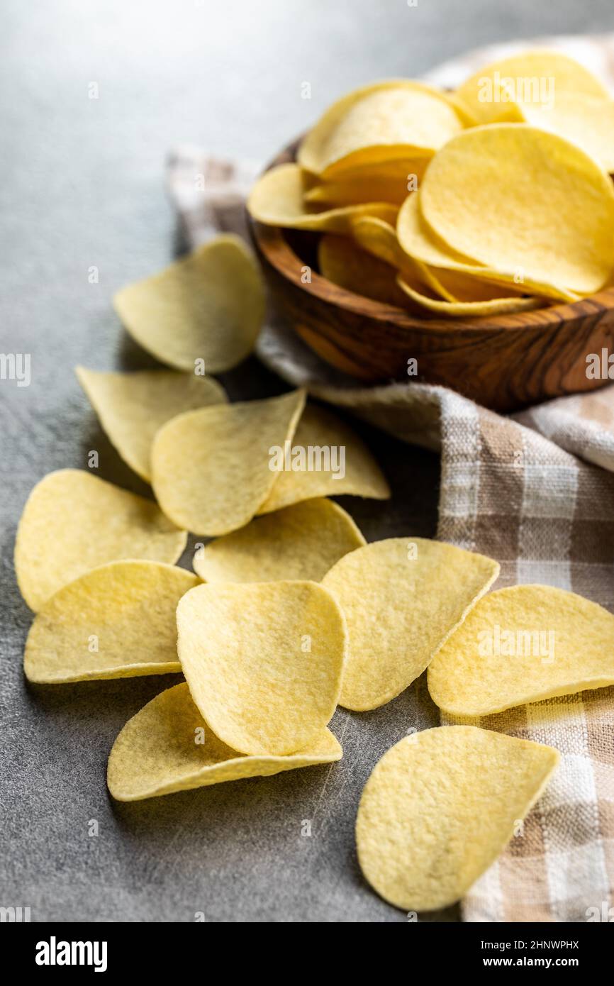 Crunchy potato chips. Potato crisps on kitchen table Stock Photo - Alamy