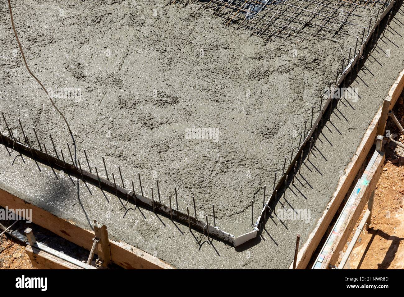 detail of iron rod at a concrete foundation with wet cement Stock Photo ...