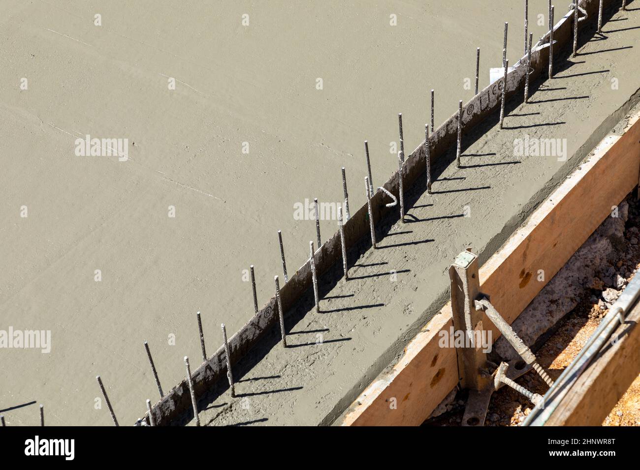 detail of iron rod at a concrete foundation with wet cement Stock Photo ...