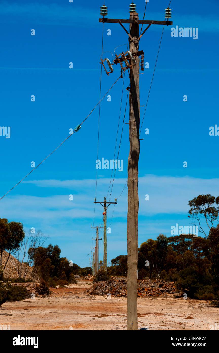 Electric Cables on Wooden Poles Stock Photo - Alamy