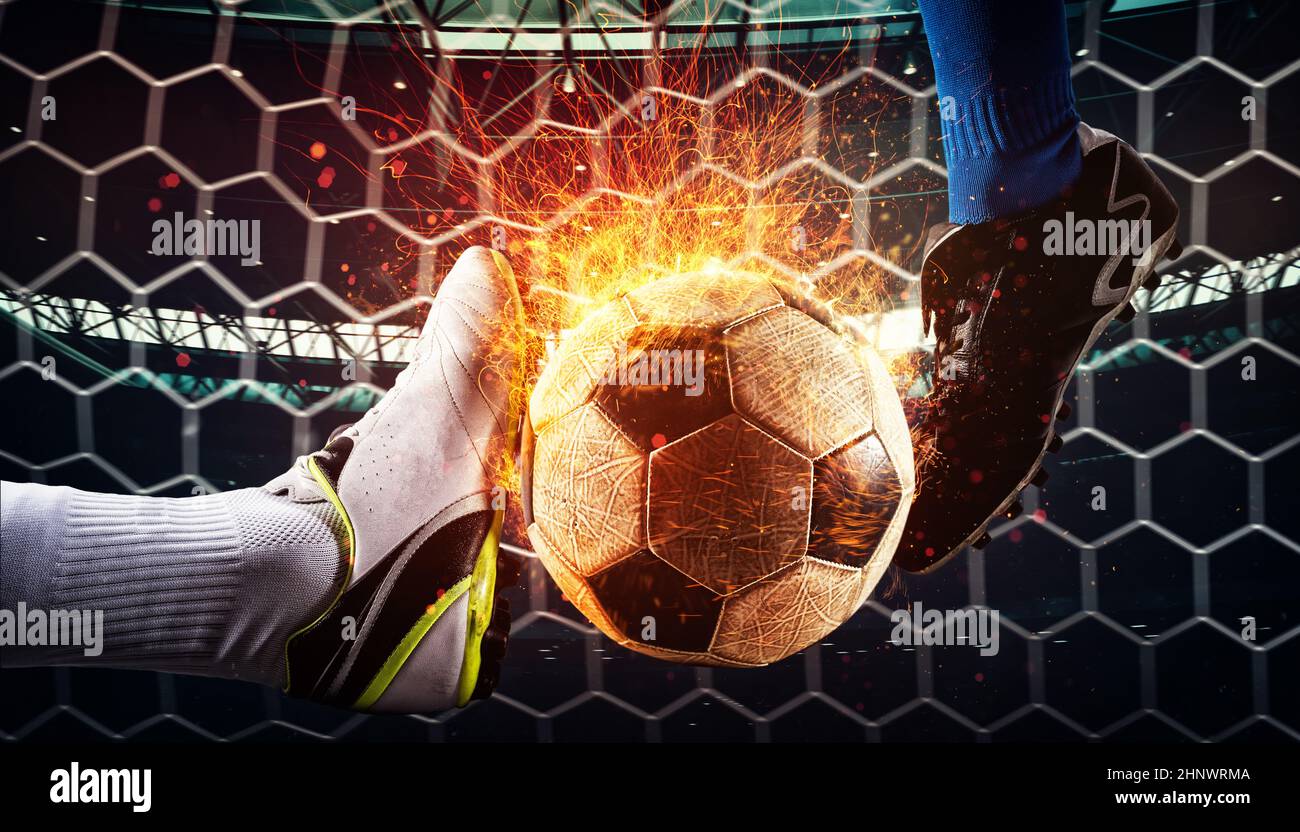 Two soccer players chase the fiery ball at the stadium Stock Photo - Alamy