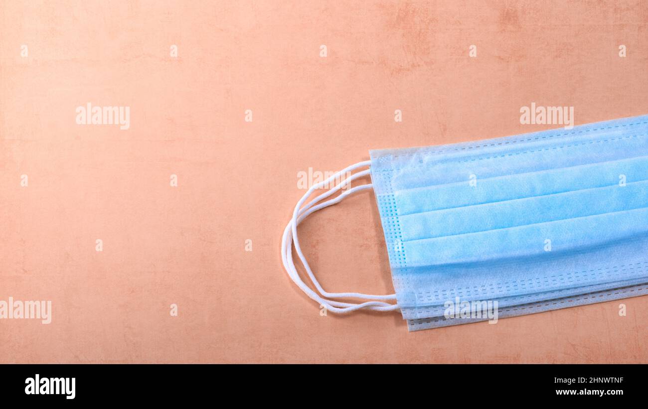 Medical mask with rubber ear straps to cover the mouth and nose. A ...