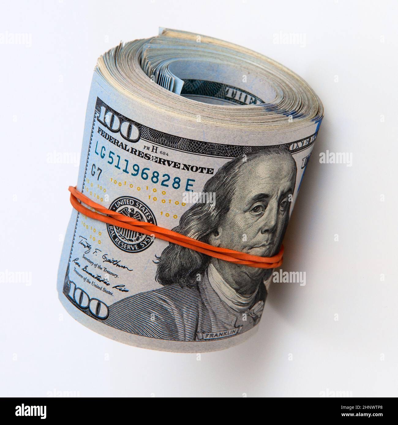 A roll of dollars on a white background. One hundred American dollar ...