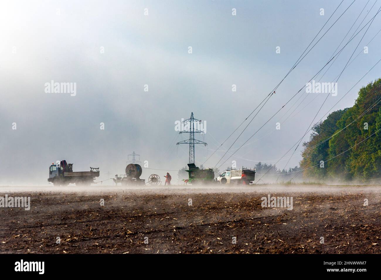 electricity pylon in fog is build up at the field Stock Photo - Alamy