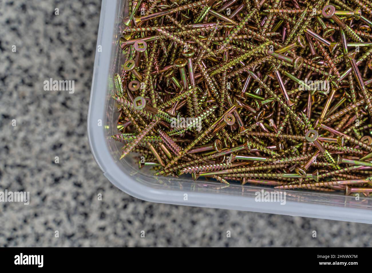 Galvanized deck screws in bucket in a factory workshop Stock Photo - Alamy