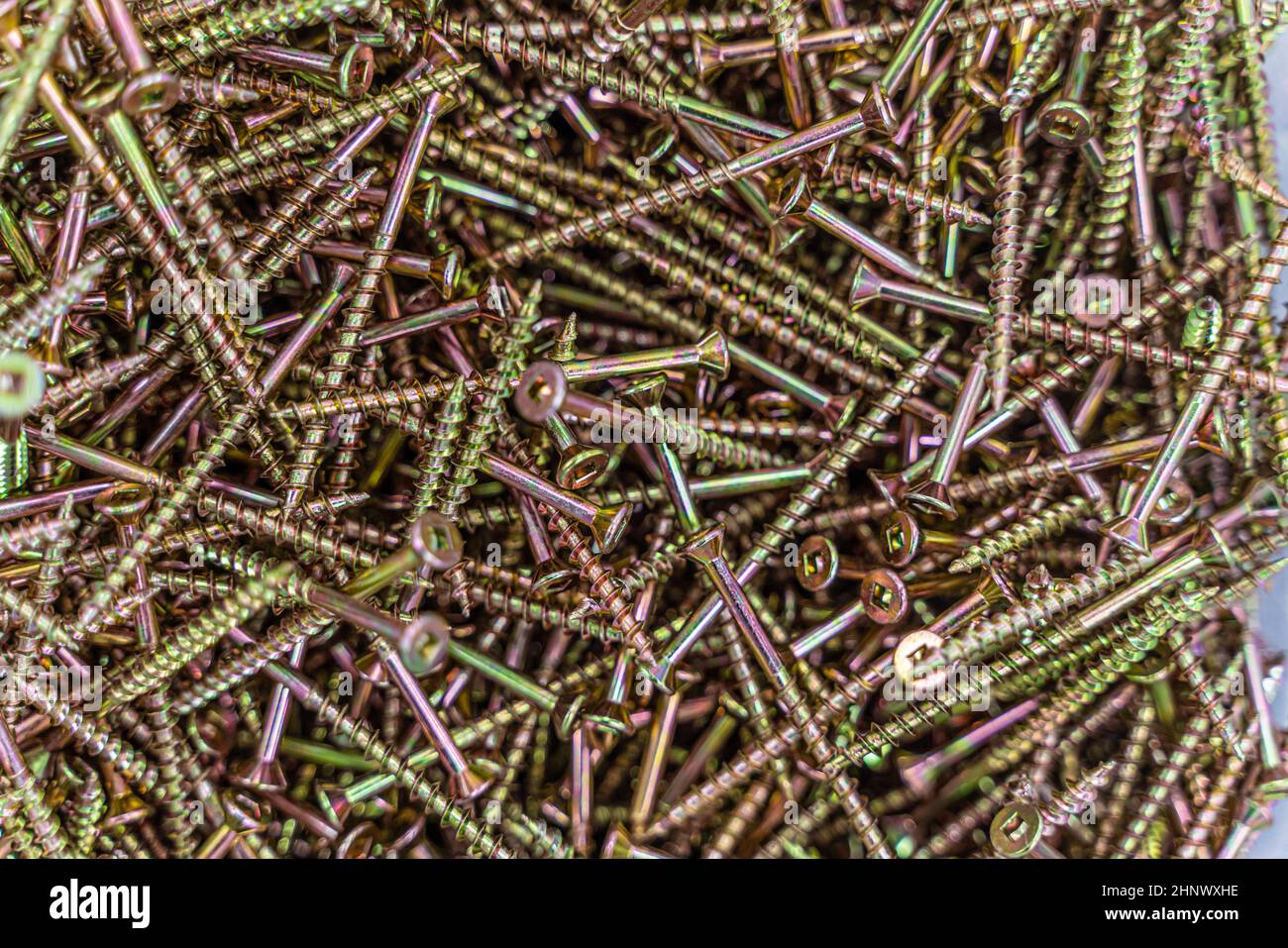 Galvanized deck screws in bucket in a factory workshop Stock Photo - Alamy