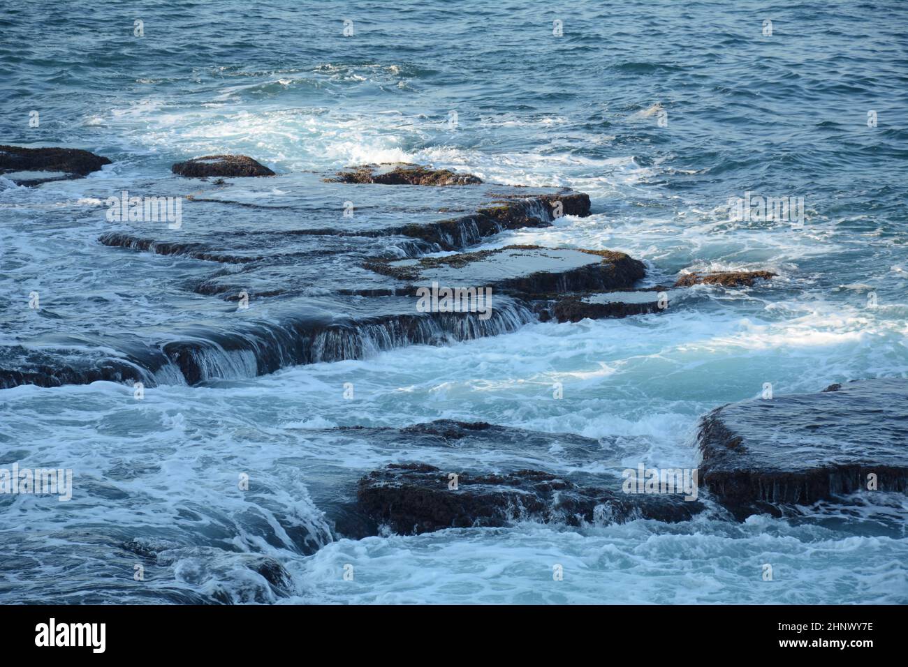 Sea Waves Crashing on the Rocks with White Foam. Swirling frothy foamy ...