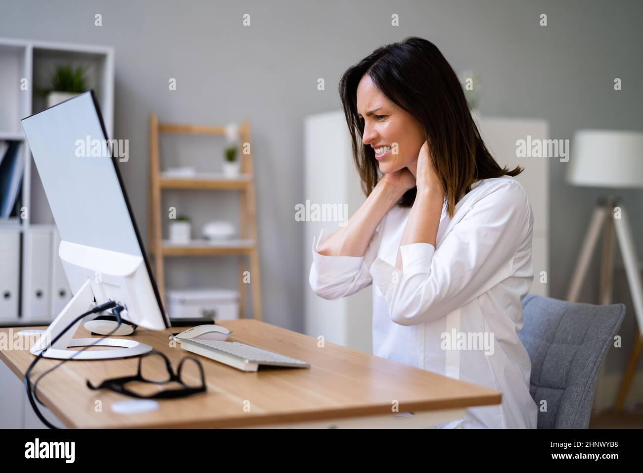 Neck Pain While Working At Computer. Bad Posture Stress Stock Photo - Alamy