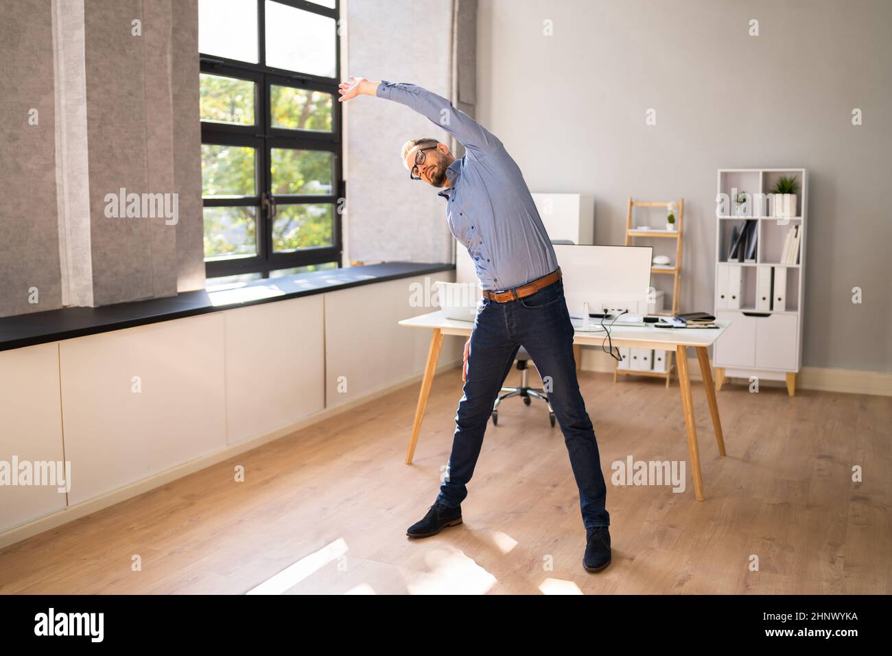 Arms Stretch Exercise Standing In Front Of Computer Stock Photo - Alamy
