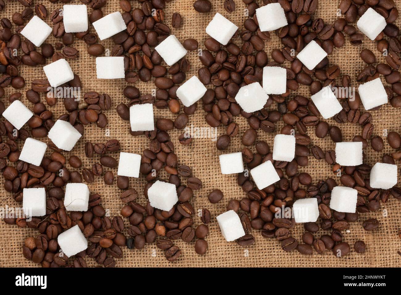 Lump sugar and coffee beans on sackcloth can use as background Stock ...