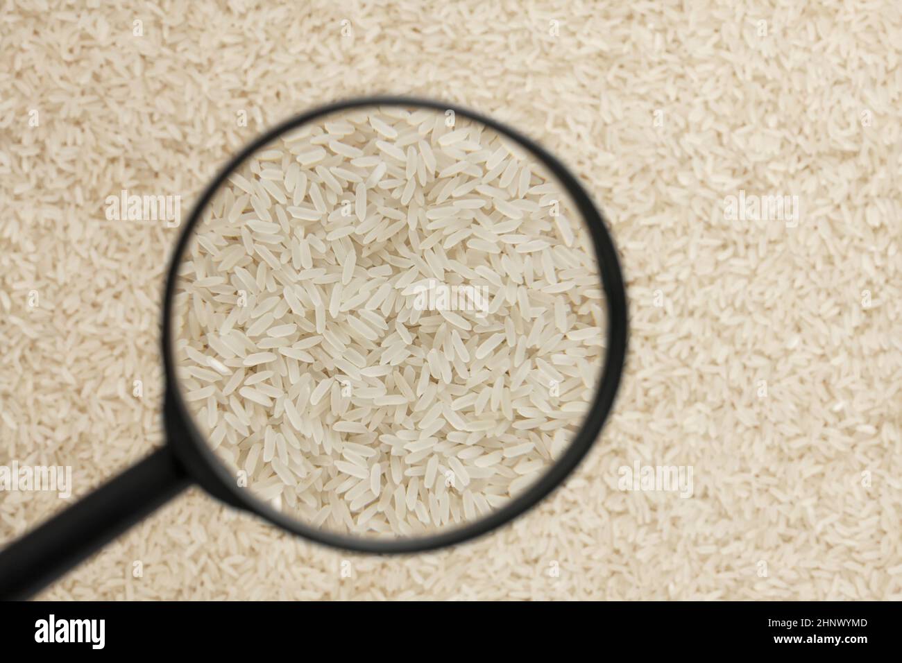 Rice in the magnifying glass as the background Stock Photo - Alamy