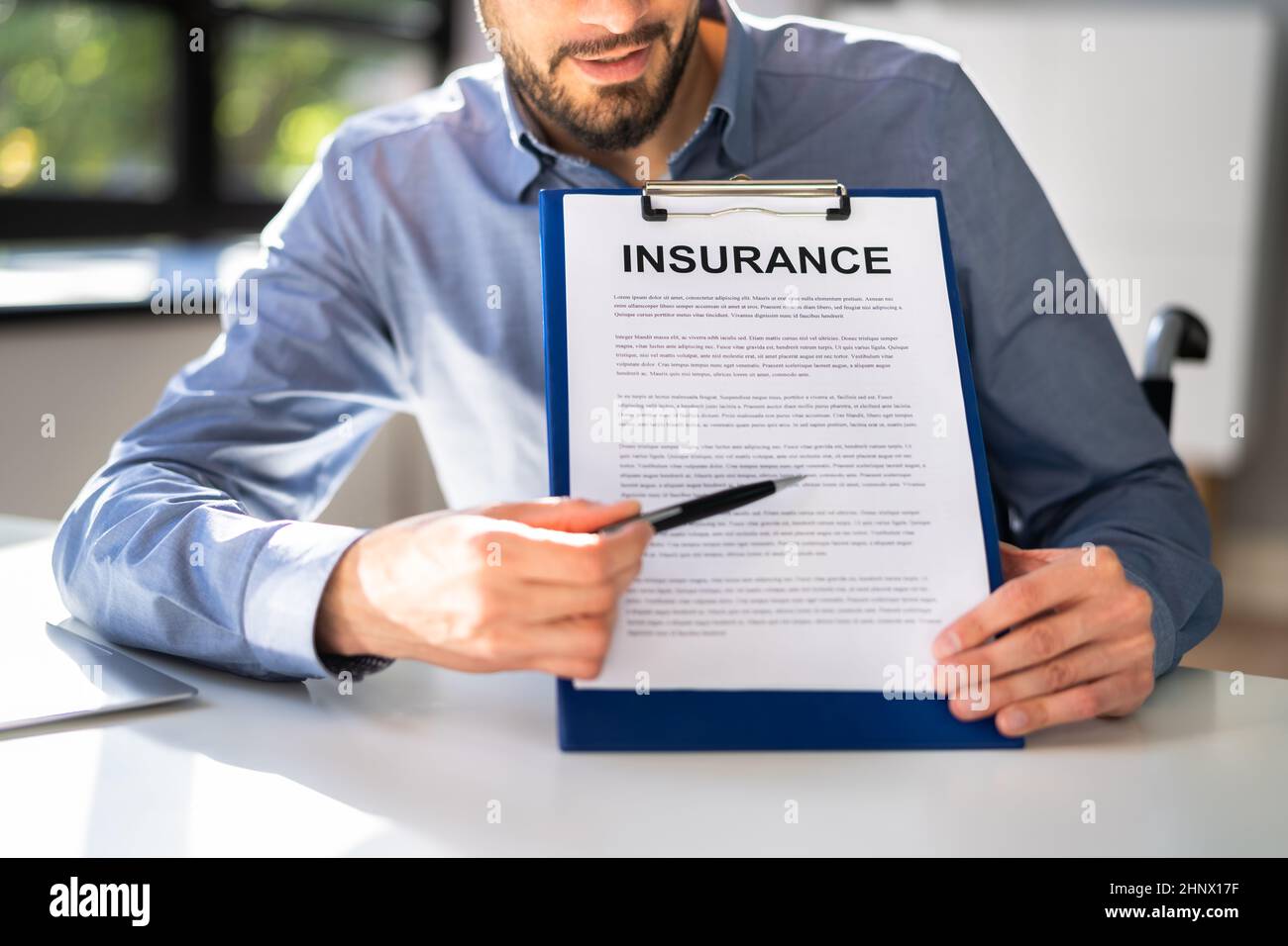 Male Agent Showing Company Insurance Policy Document Stock Photo - Alamy