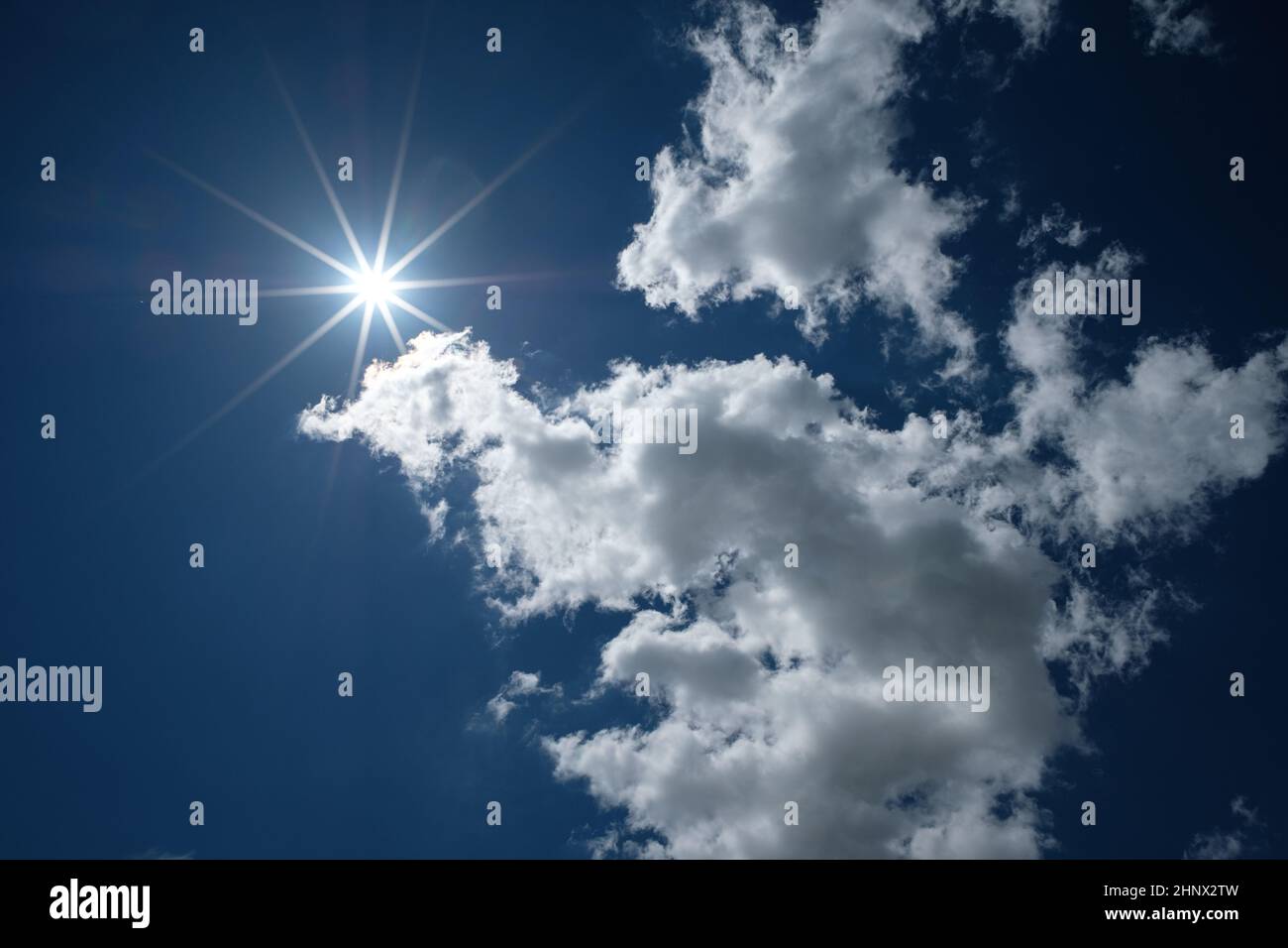 Sunlight with rays in the blue sky with clouds back lit Stock Photo - Alamy