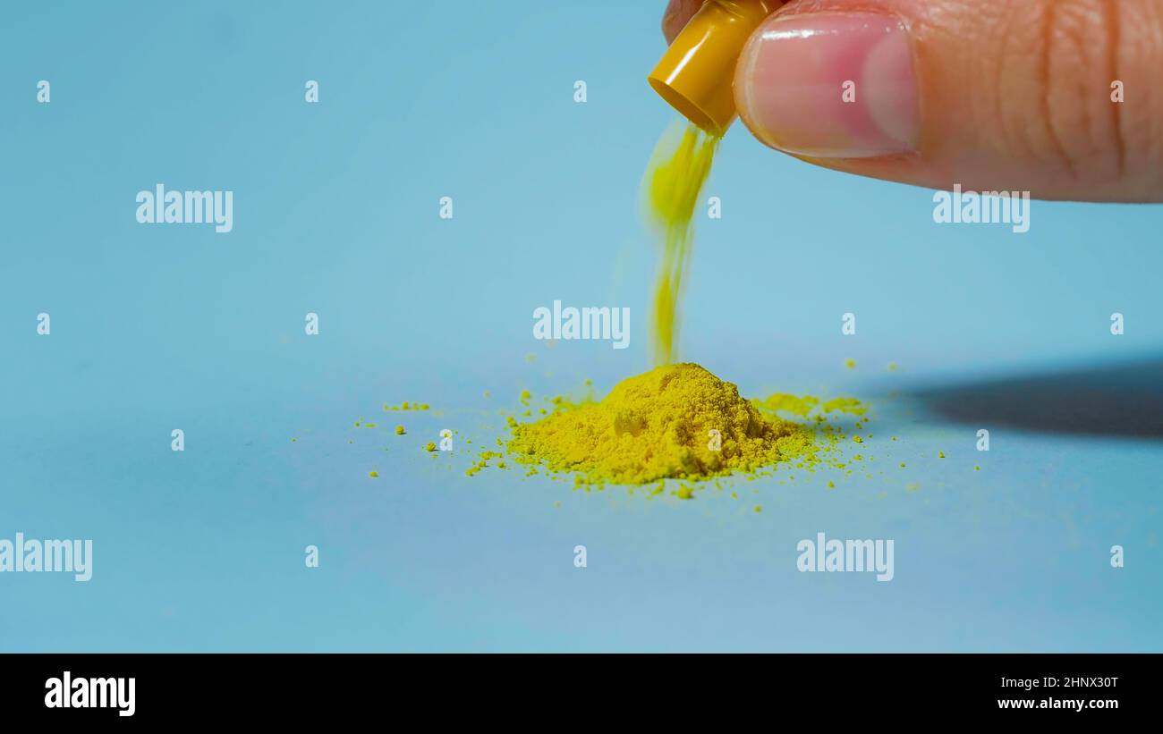Powder of pills. Yellow medicine from a capsule. Pharmaceutical Concept ...