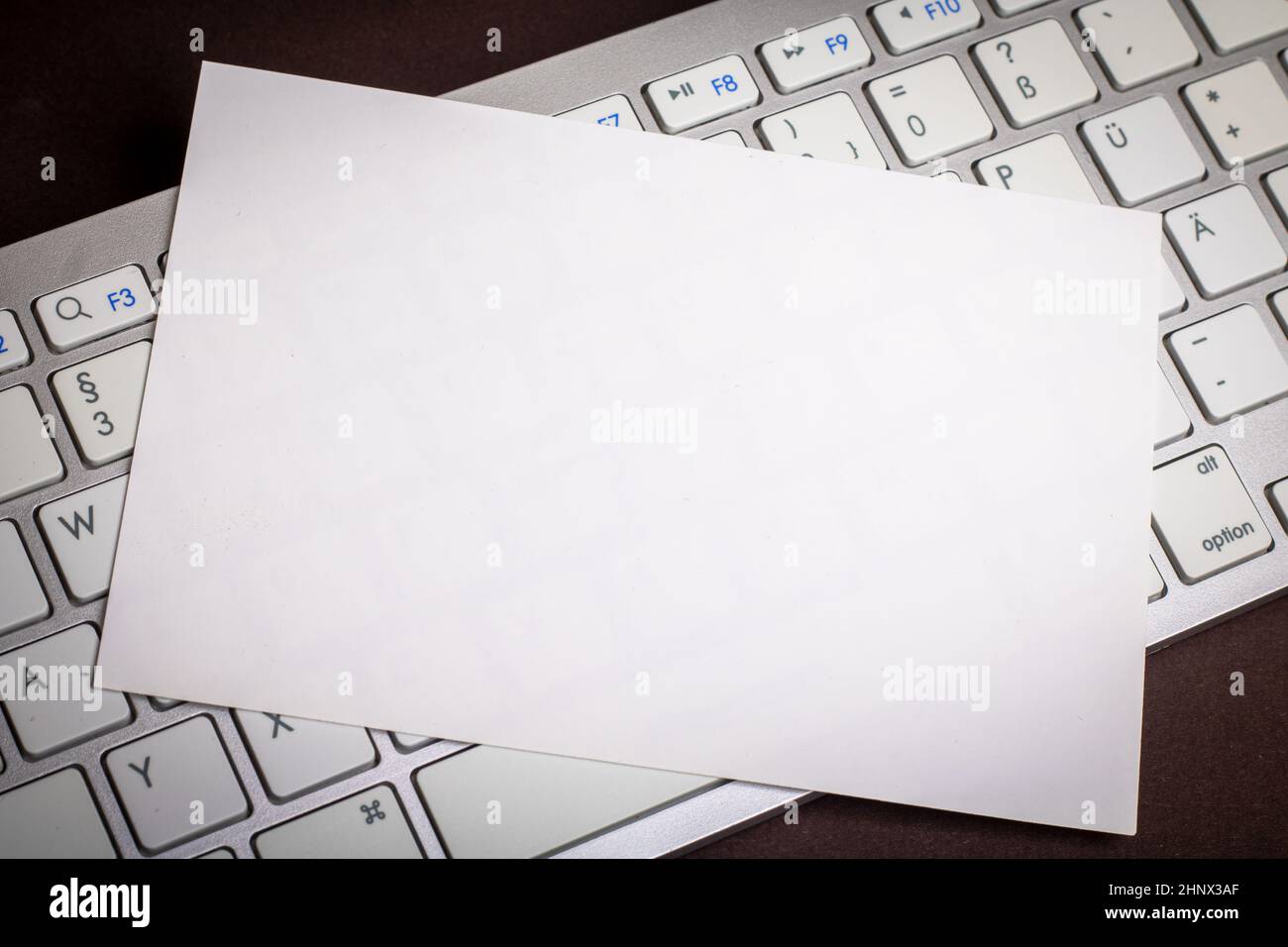 white sheet of paper on computer keyboard as design element ...