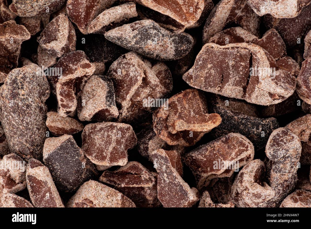 Pieces of broken cocoa beans - also called chocolate nibs, detail under ...