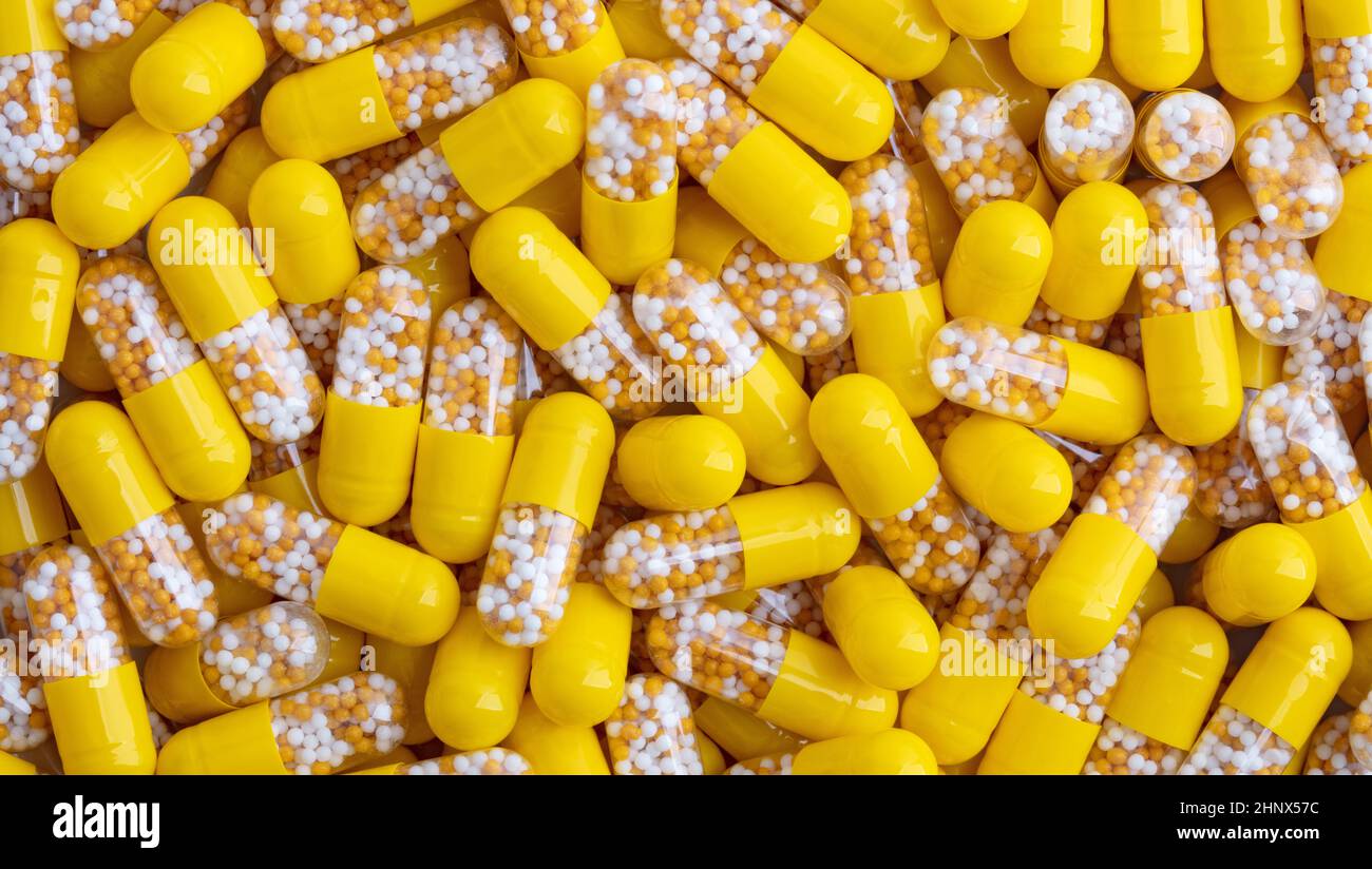 Yellow capsules full frame in detail using for background Stock Photo ...