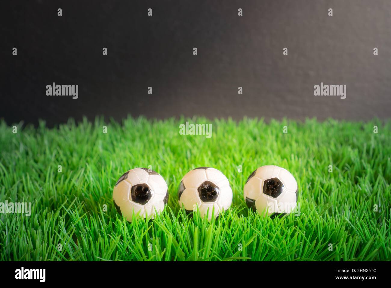 Three soccer balls on the football field Stock Photo - Alamy