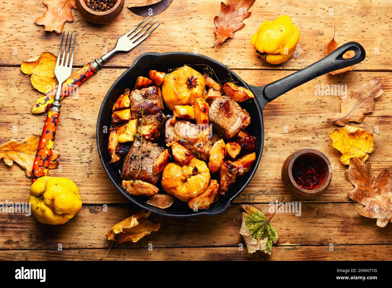 Roasted pork meat with autumn quince in pan Stock Photo - Alamy