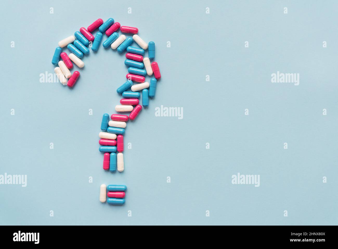 A question mark which consists of three different colorful vitamins on ...