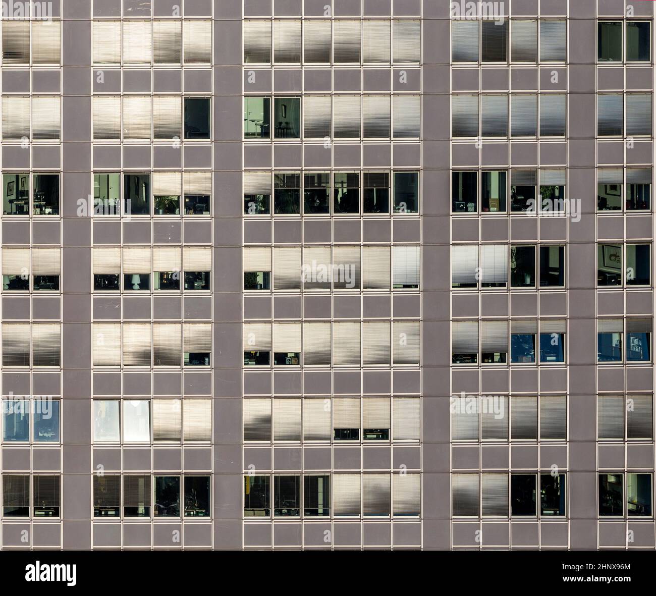 pattern of office facade with windows and shutter blinds as symbol for ...