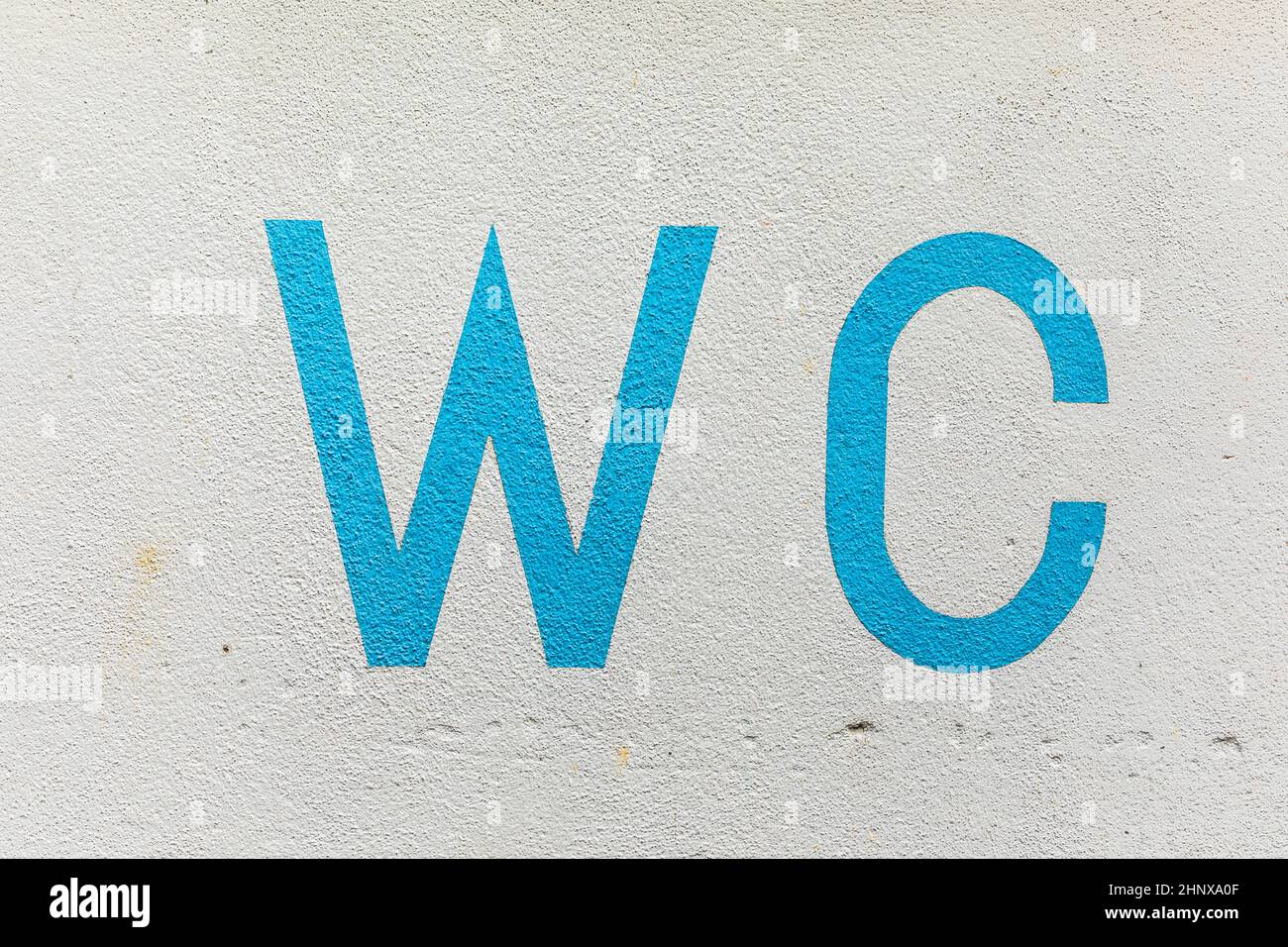 sign WC - water closet at a white wall Stock Photo - Alamy