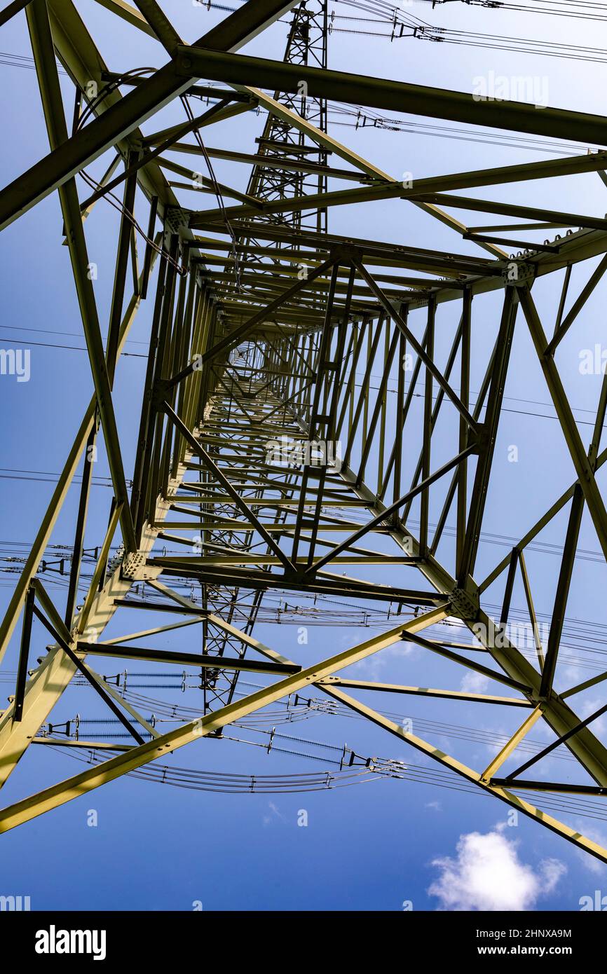 electric pylon under blue sky as industry background Stock Photo - Alamy