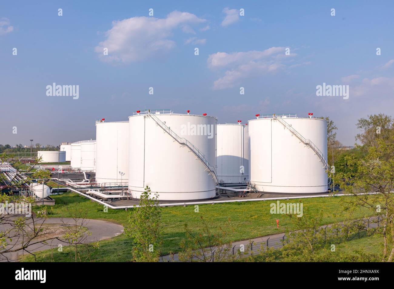white oil tanks under blue sky Stock Photo - Alamy