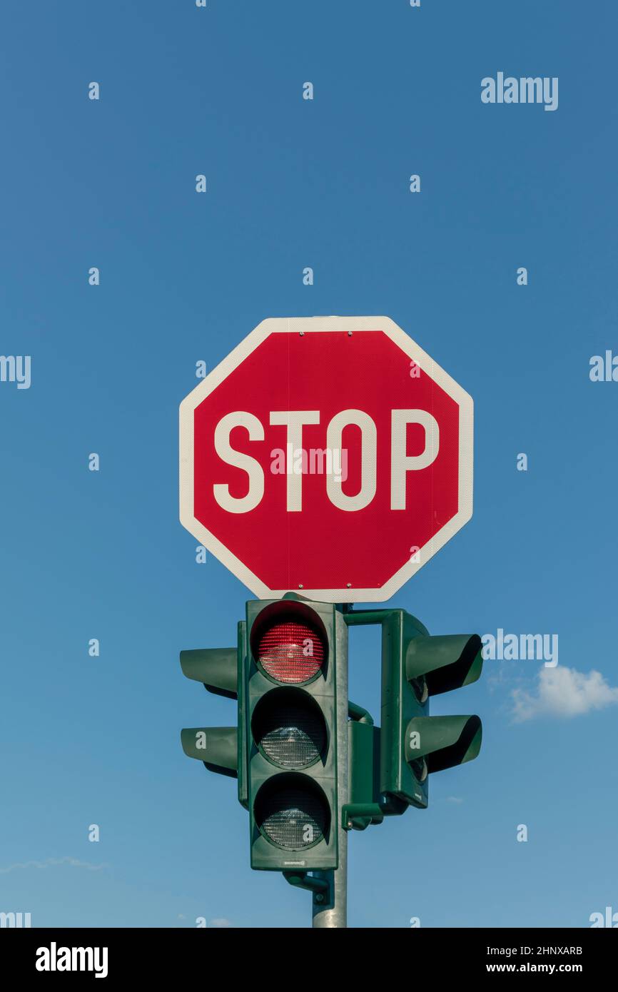 red traffic sign and stop sign under clear blue sky Stock Photo - Alamy