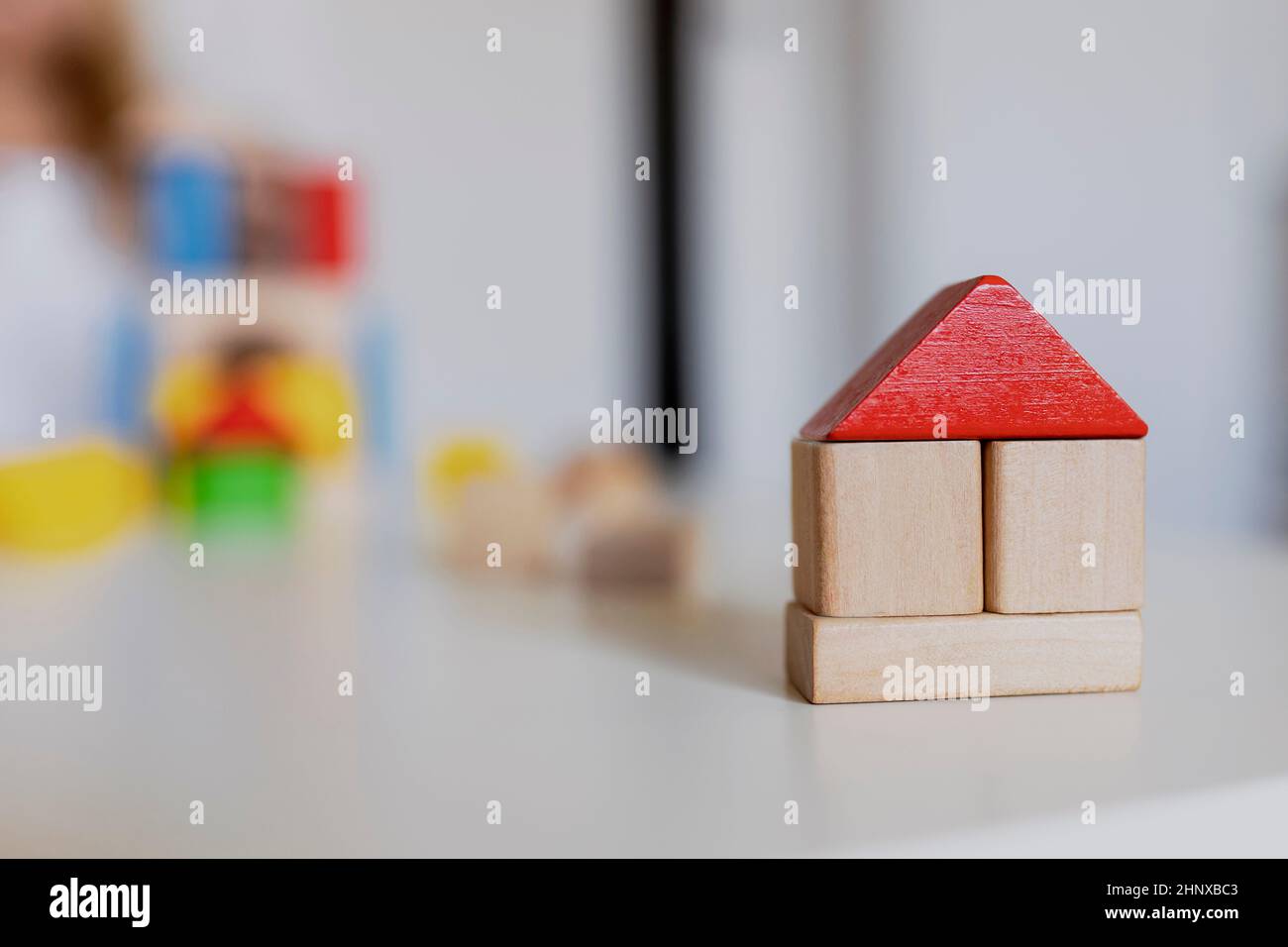 Child girl playing with colorful wooden toy building blocks. Little kid ...