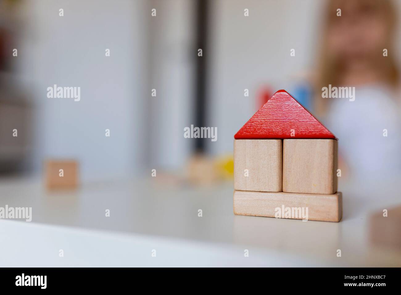 Child girl playing with colorful wooden toy building blocks. Little kid ...