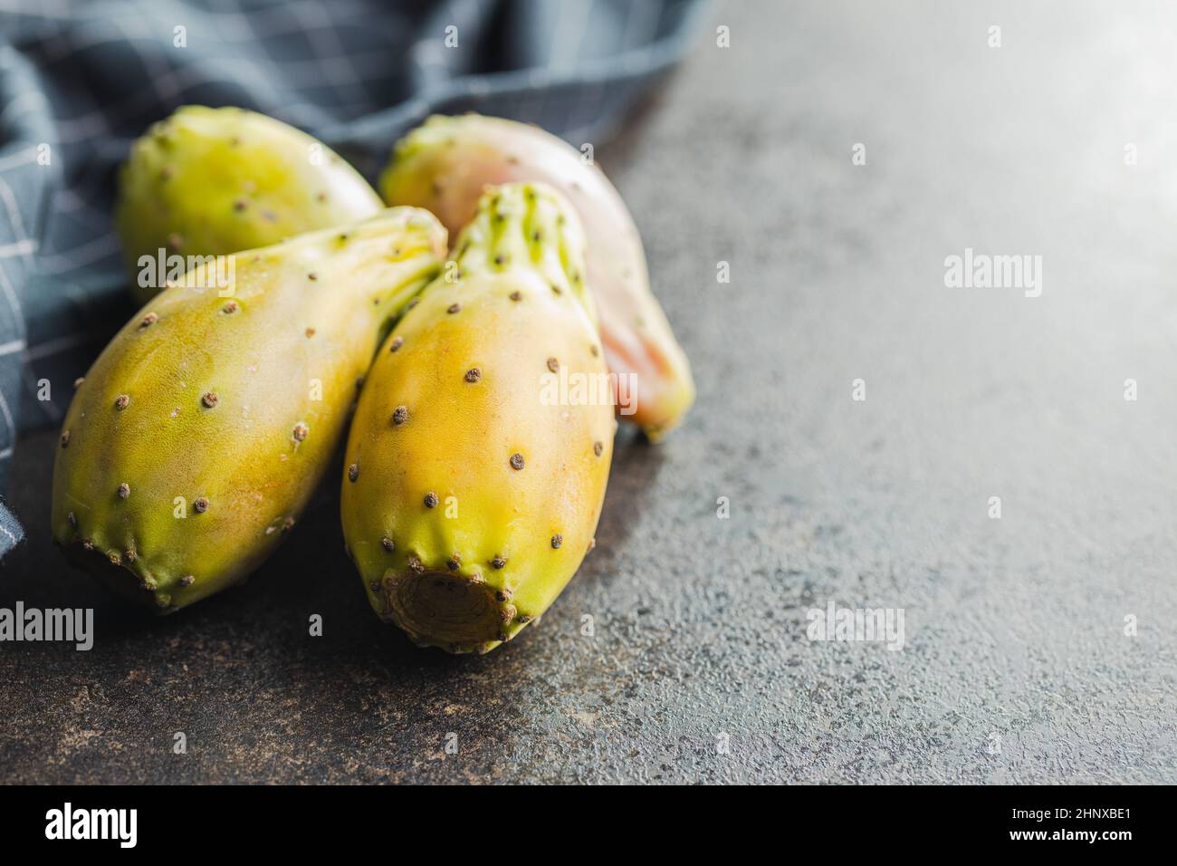 Raw prickly pears. Opuntia or indian fig cactus on kitchen table Stock ...