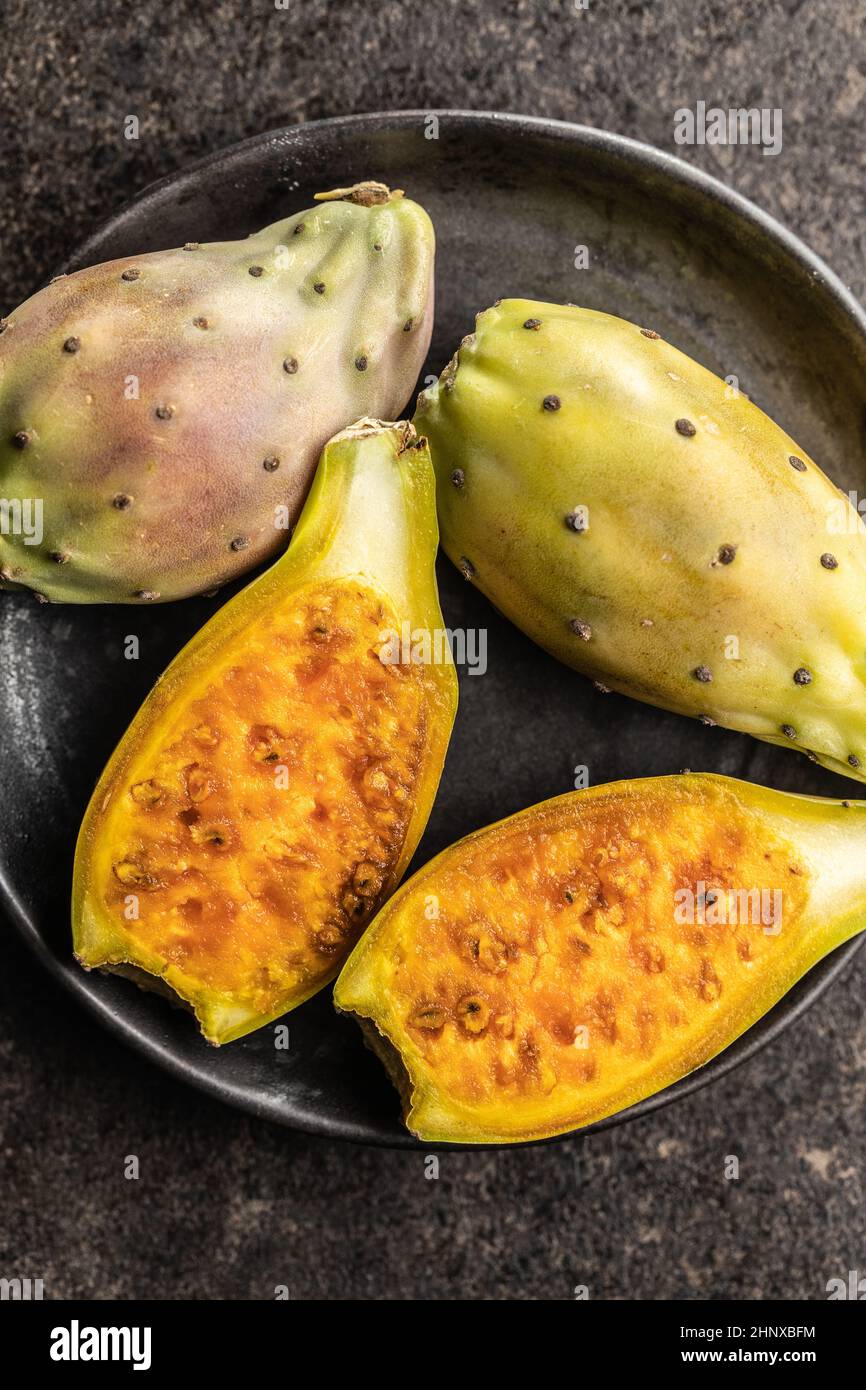 Raw prickly pears. Opuntia or indian fig cactus on plate. Top view ...