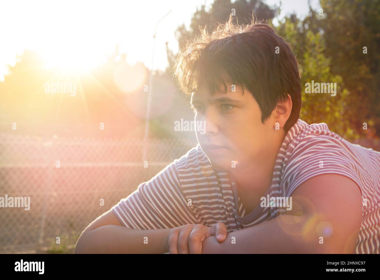 Happy handsome boy posing outdoors at sunset Stock Photo - Alamy