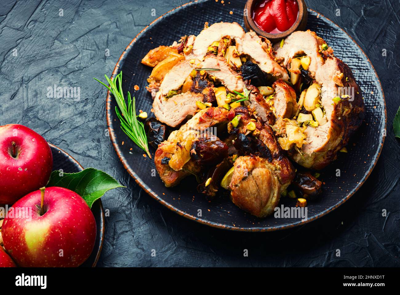 Homemade baked lean pork roll with apples and dates. Roasted meat roll ...
