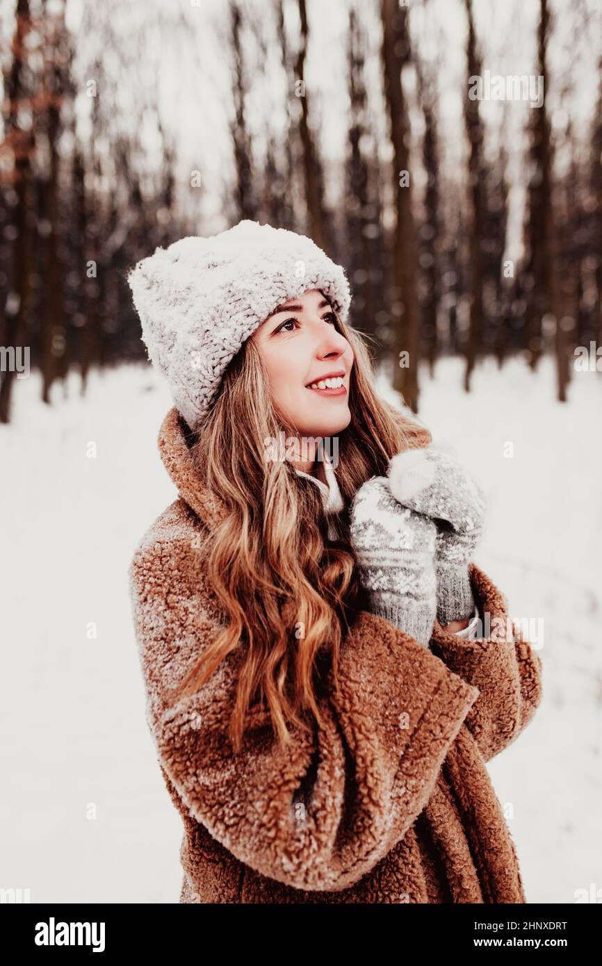 Beautiful young woman in snowy fancy winter woodland. Girl wearing ...