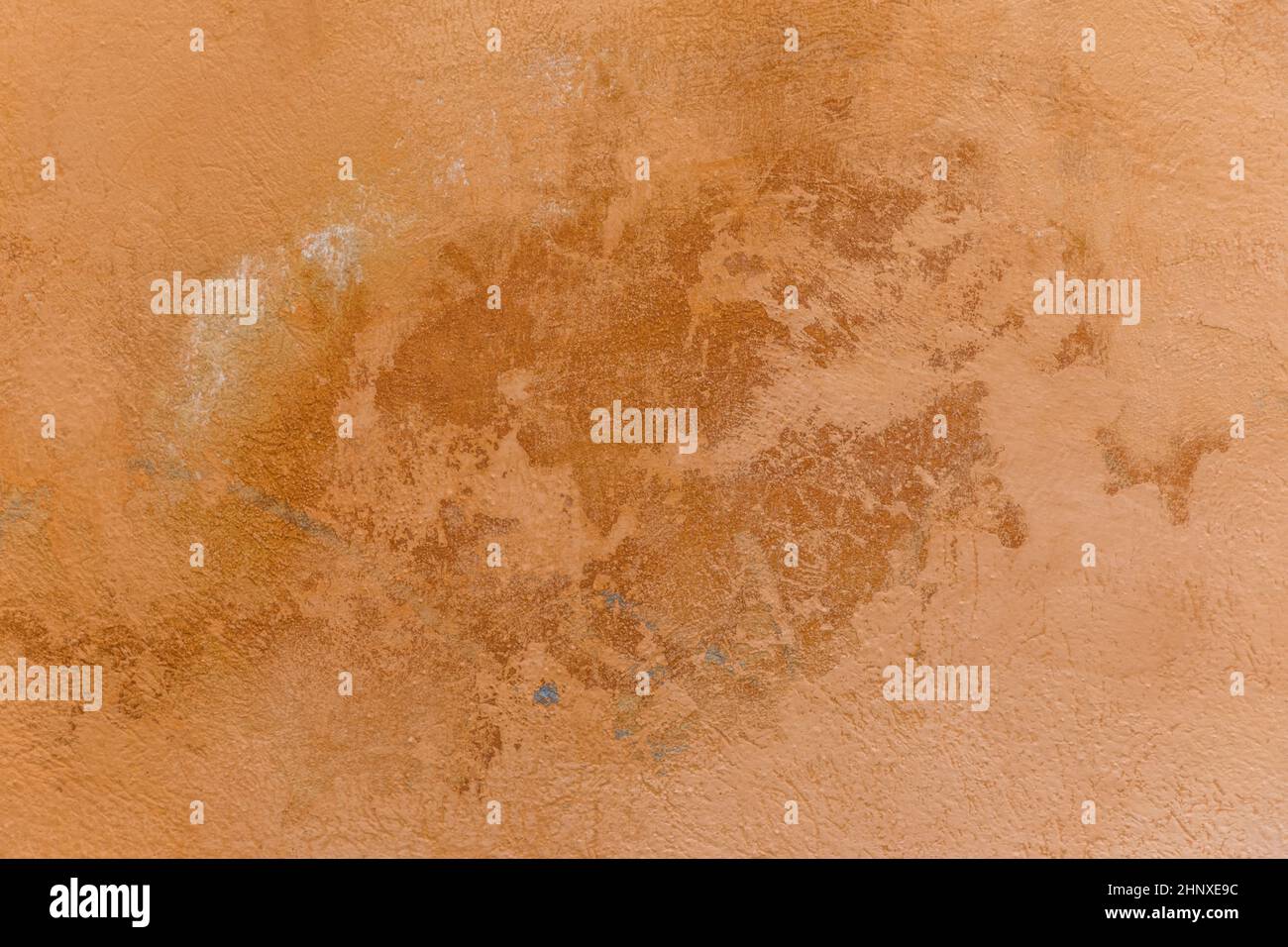 typical painted orange plaster wall of an old house in the provence ...