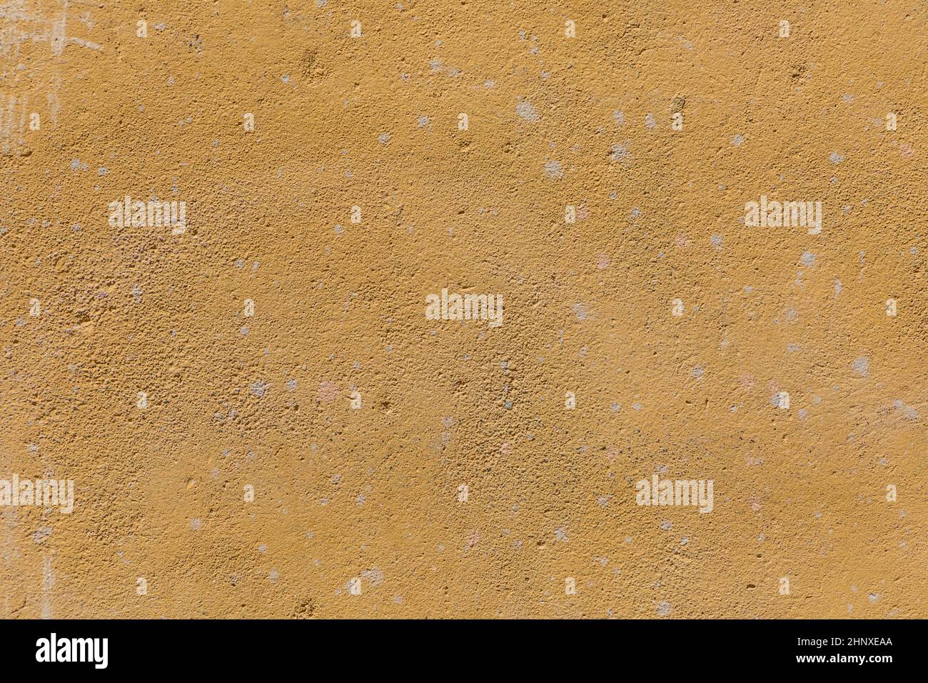 typical painted orange plaster wall of an old house in the provence ...