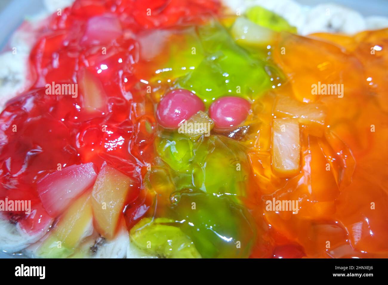 Creamy custard sweet dish with with different slices layered on surface ...
