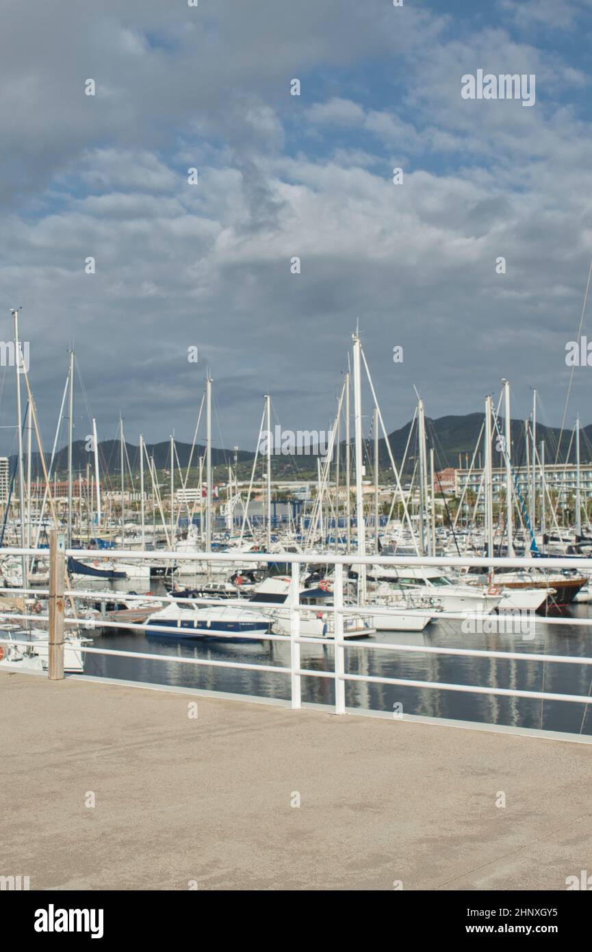 yacht and boats recreational port walkway with clouds and mountains in ...