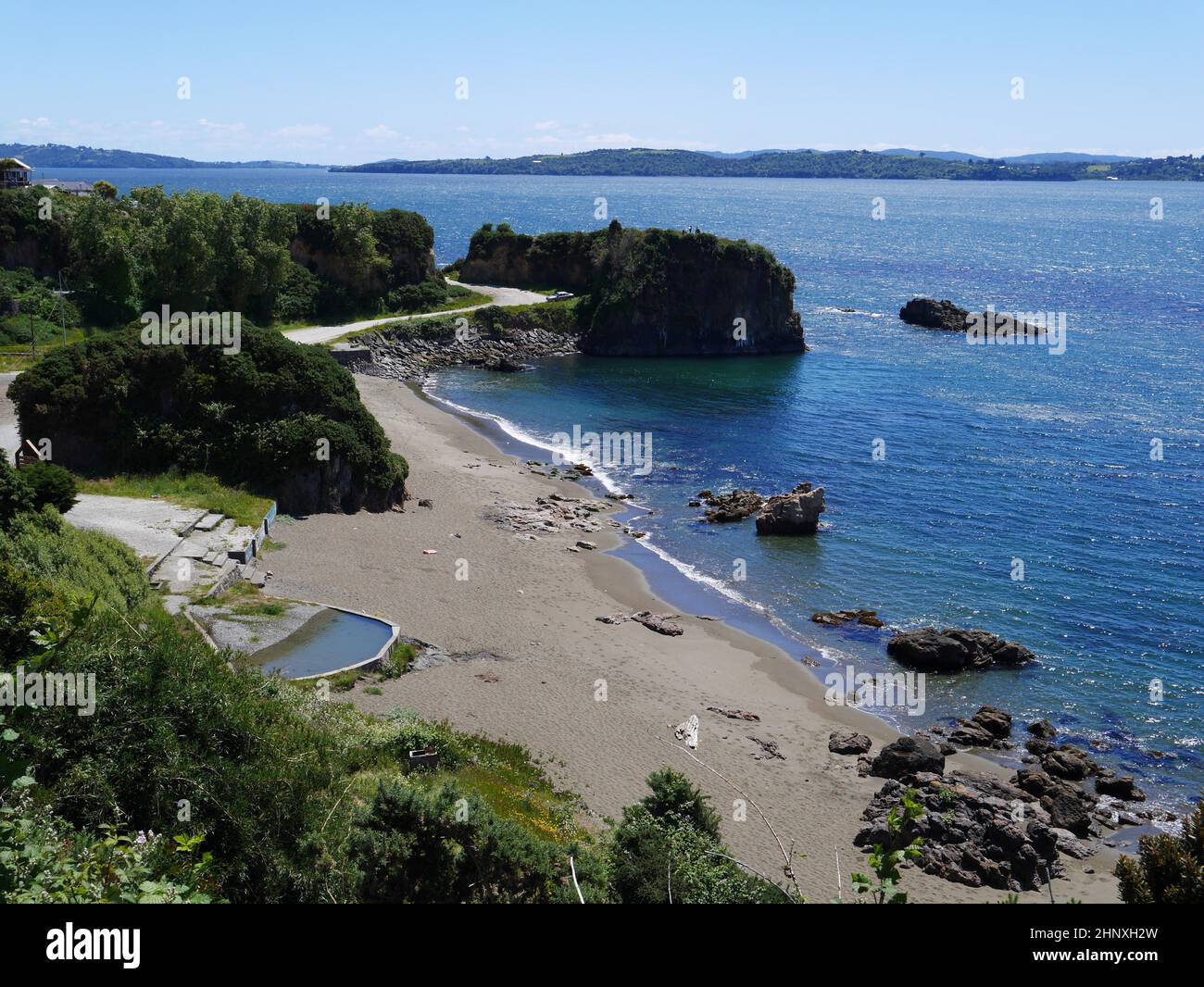 Aerial view of a beautiful sandy beach with calm waves hitting the ...