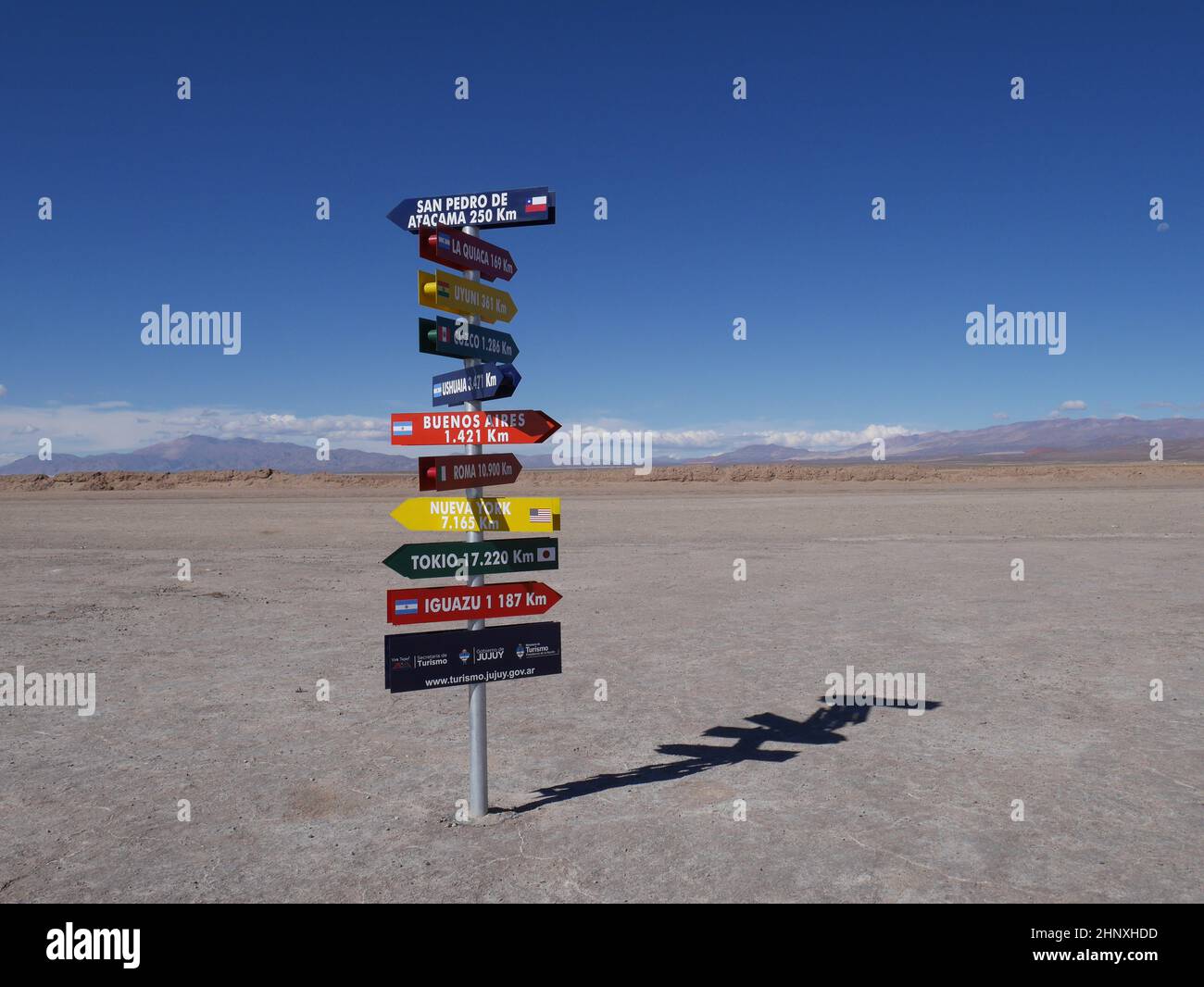 Colorful signpost in the desert showing the ways to different cities ...