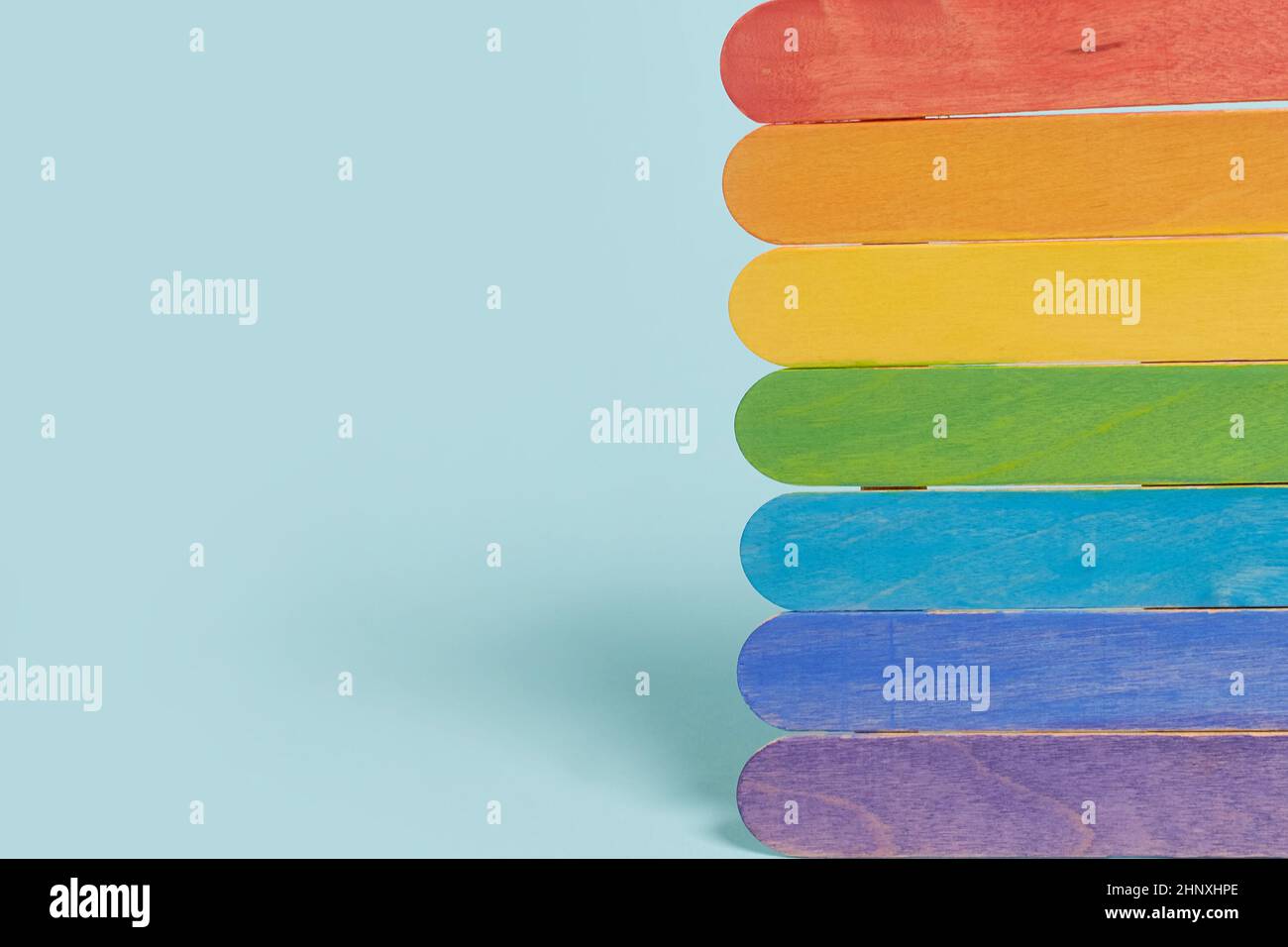 Rainbow-colored plaques on a blue background. Copy space Stock Photo ...