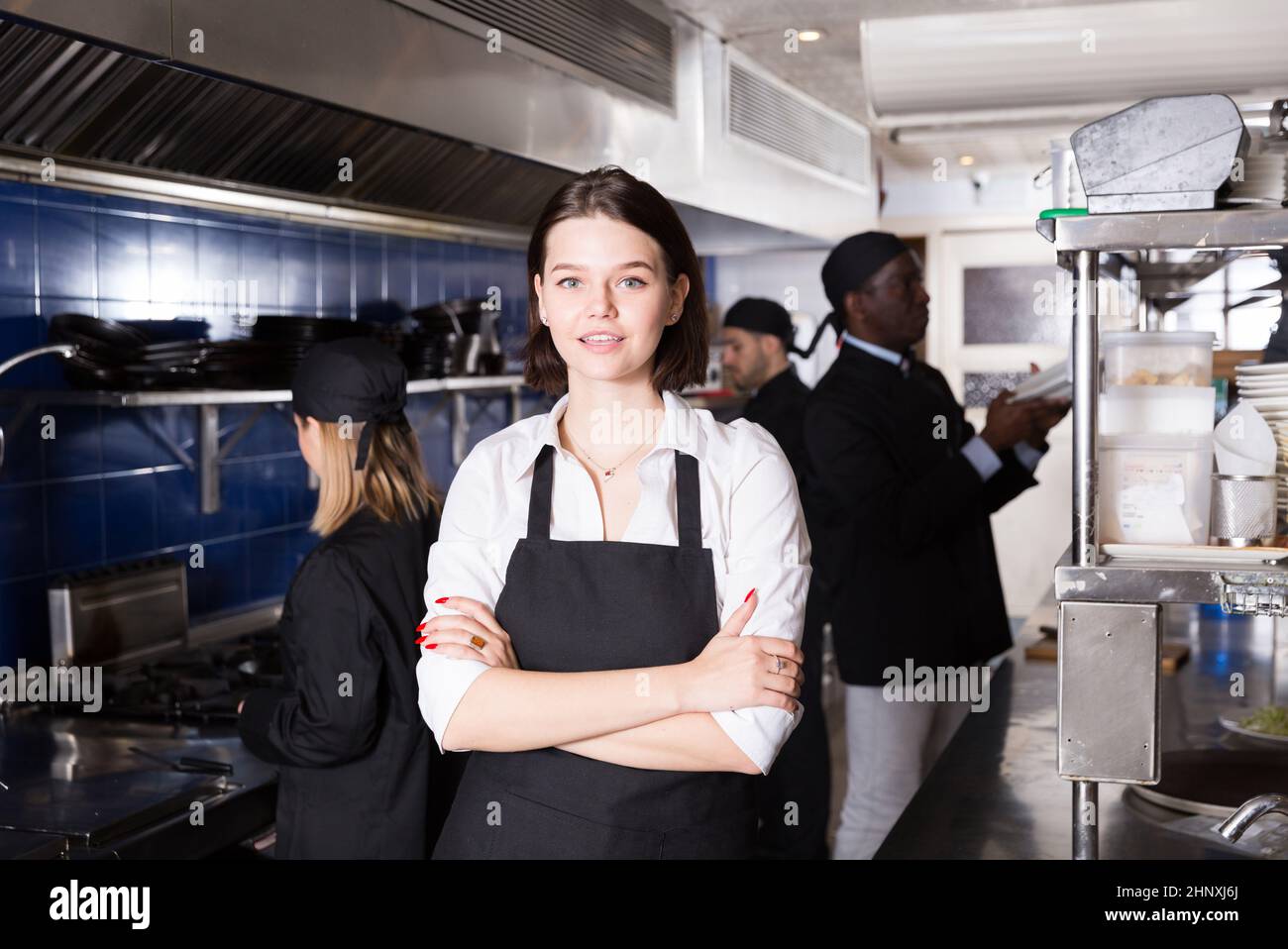 Waitress in restaurant kitchen Stock Photo - Alamy