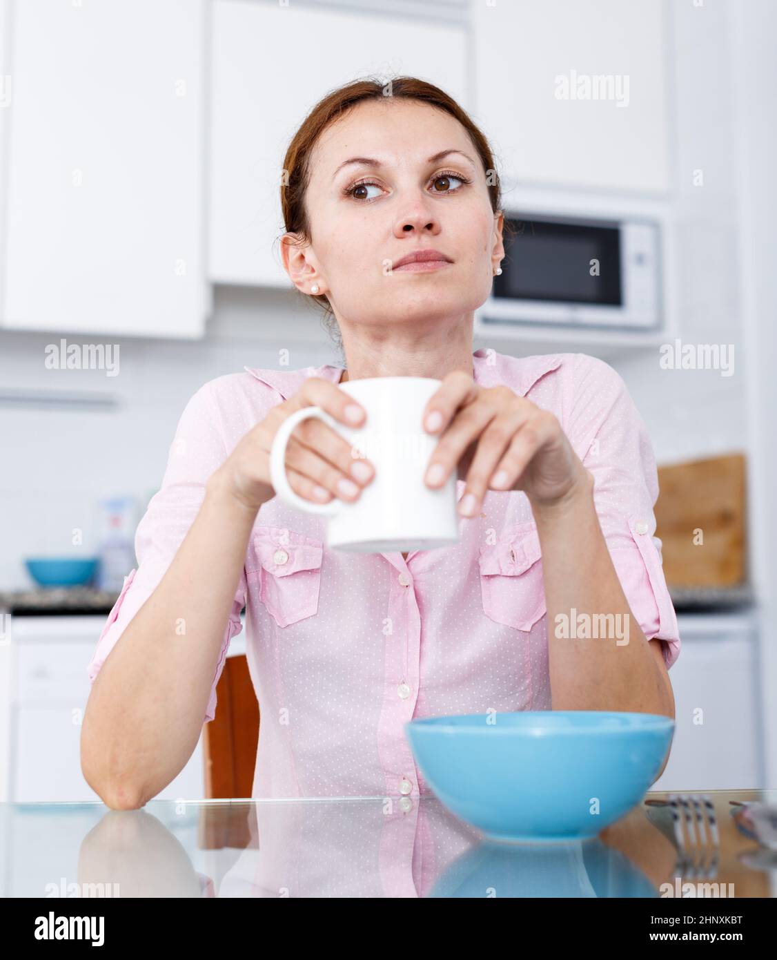 Woman having breakfast Stock Photo - Alamy