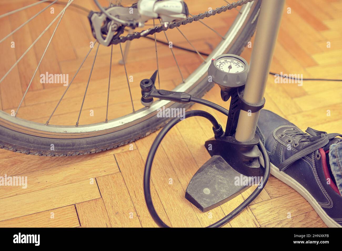 Inflating the tire of a bicycle. Home maintenance of bike. Bicycle ...