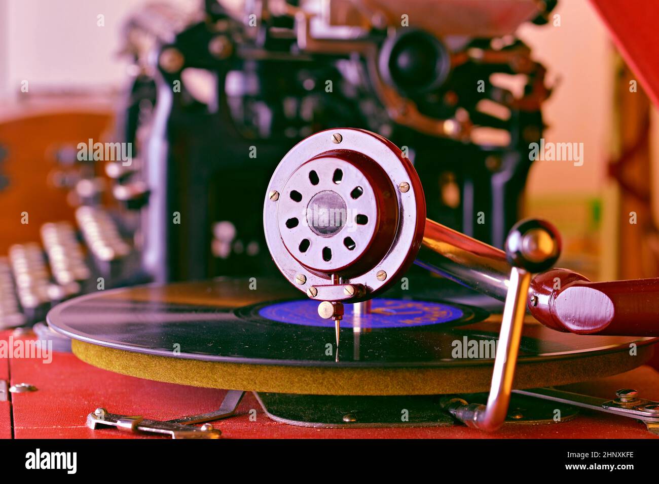 Vintage gramophone with a vinyl record on wooden table. Vintage ...