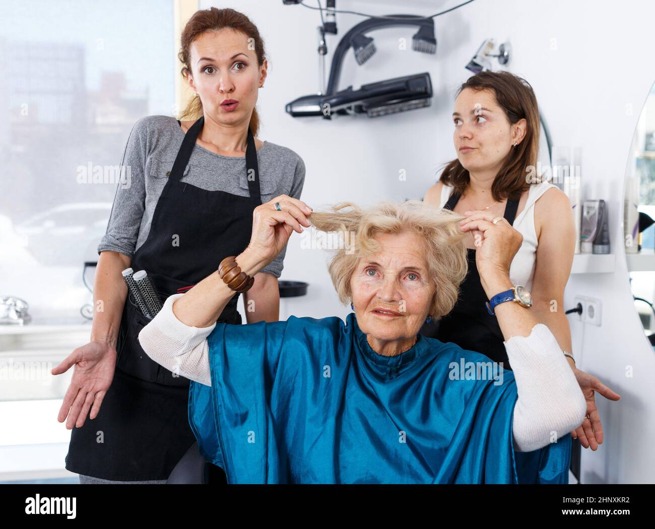 Shocked elderly female client at barbershop Stock Photo - Alamy