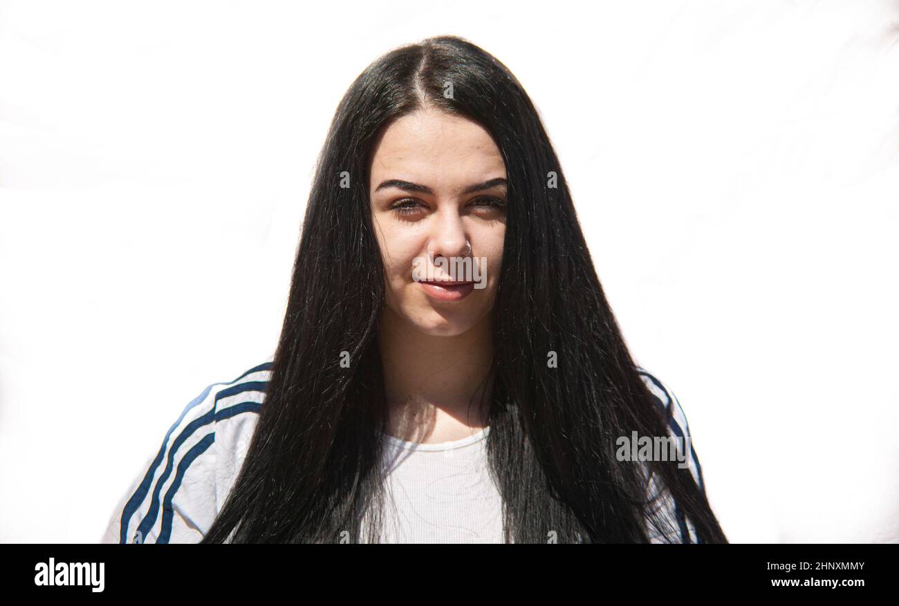 Positive slim european girl with bun hairstyle, smiling broadly while ...