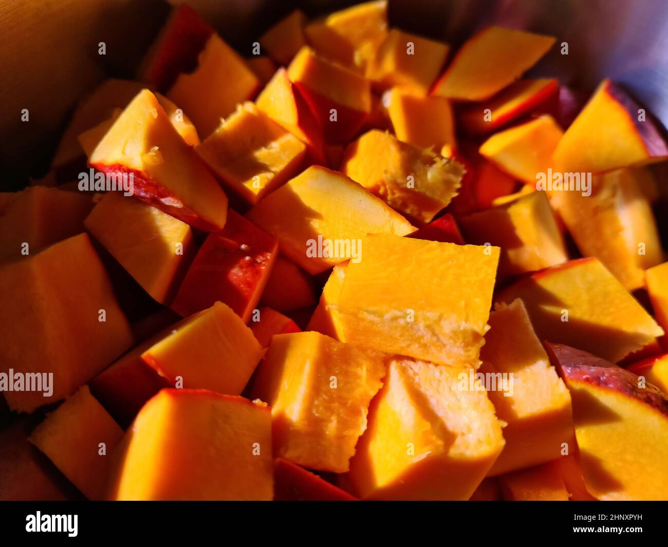 Chopped pimpkin pieces in a bowl - top view Stock Photo - Alamy